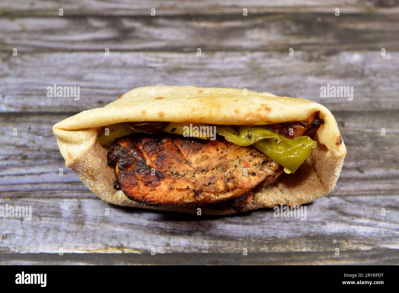 Sandwich of chicken grilled and roasted on a charcoal grill, served ...