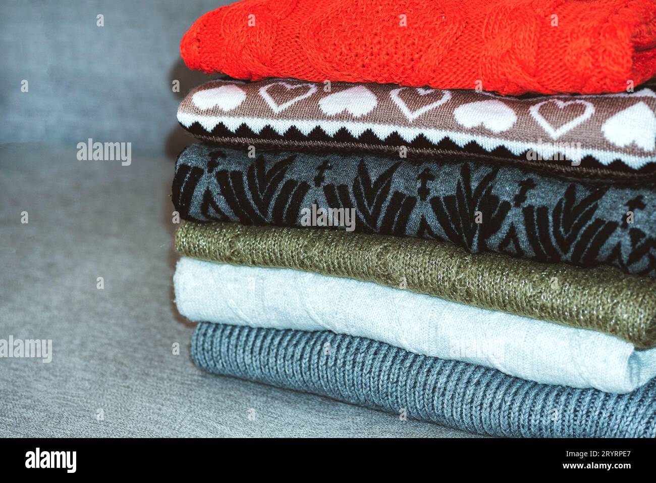A stack of sweaters, jumpers. A Bunch of colored, woolen jumpers ...