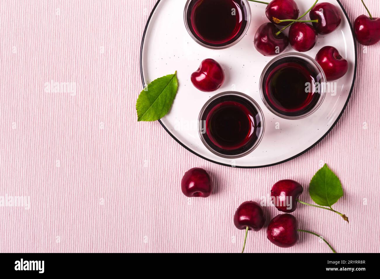 Cherry alcohol drink liquor or brandy on pink background Stock Photo ...