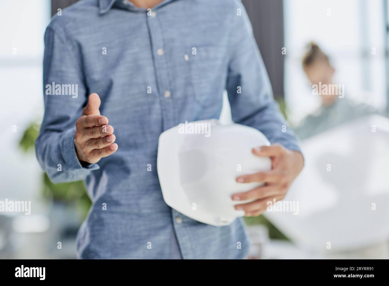 Architect and civil engineer shaking hands while holding hard hat in ...