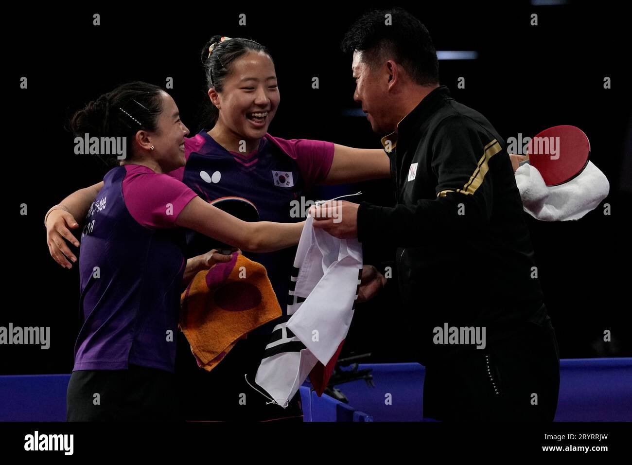 South Korea's Jeon Jihee, left and Shin Yubin hug their coach defeating North Korea in the Table ...