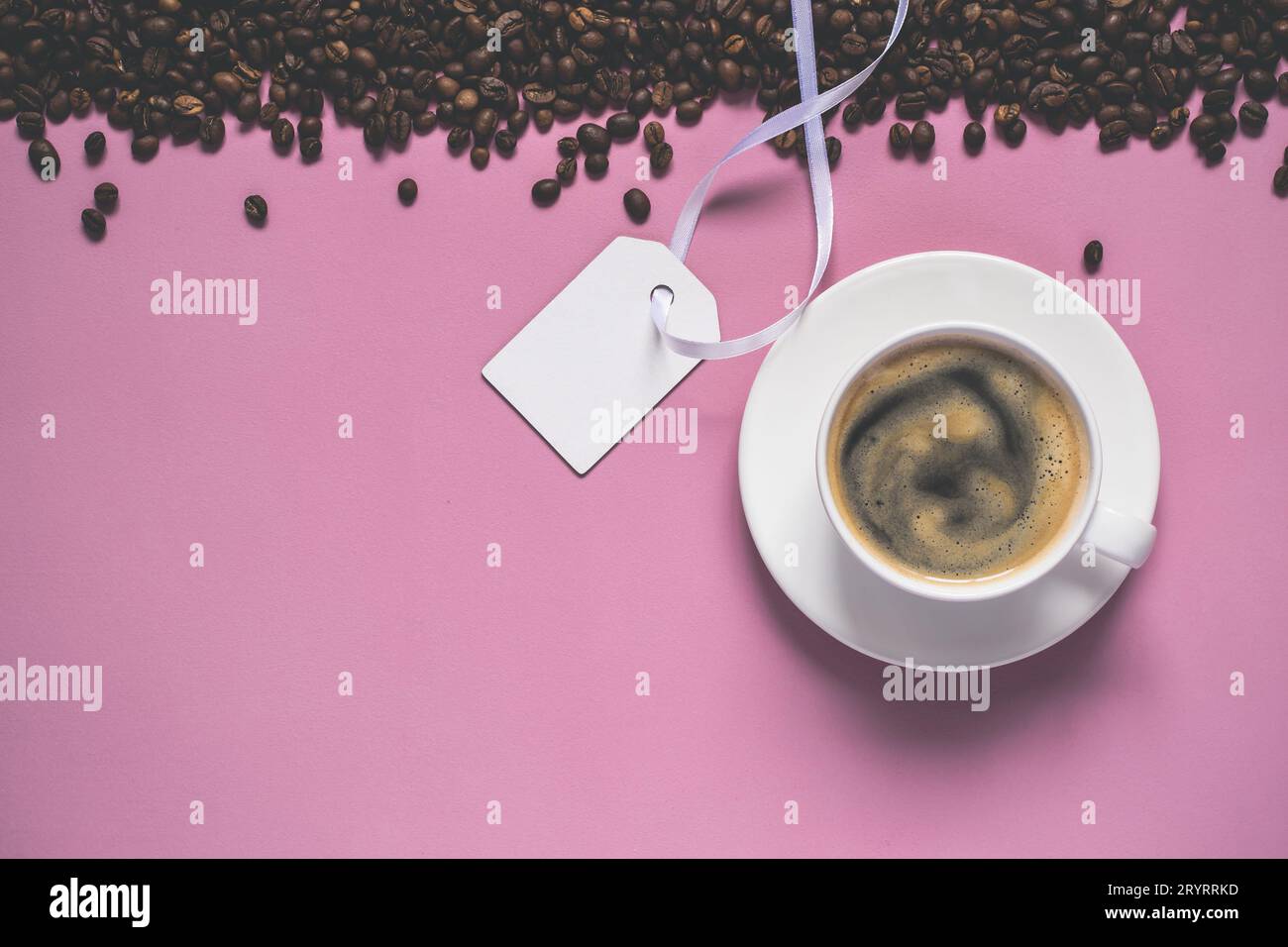 Cup of coffee with foam, beans And tag on pink background Stock Photo ...