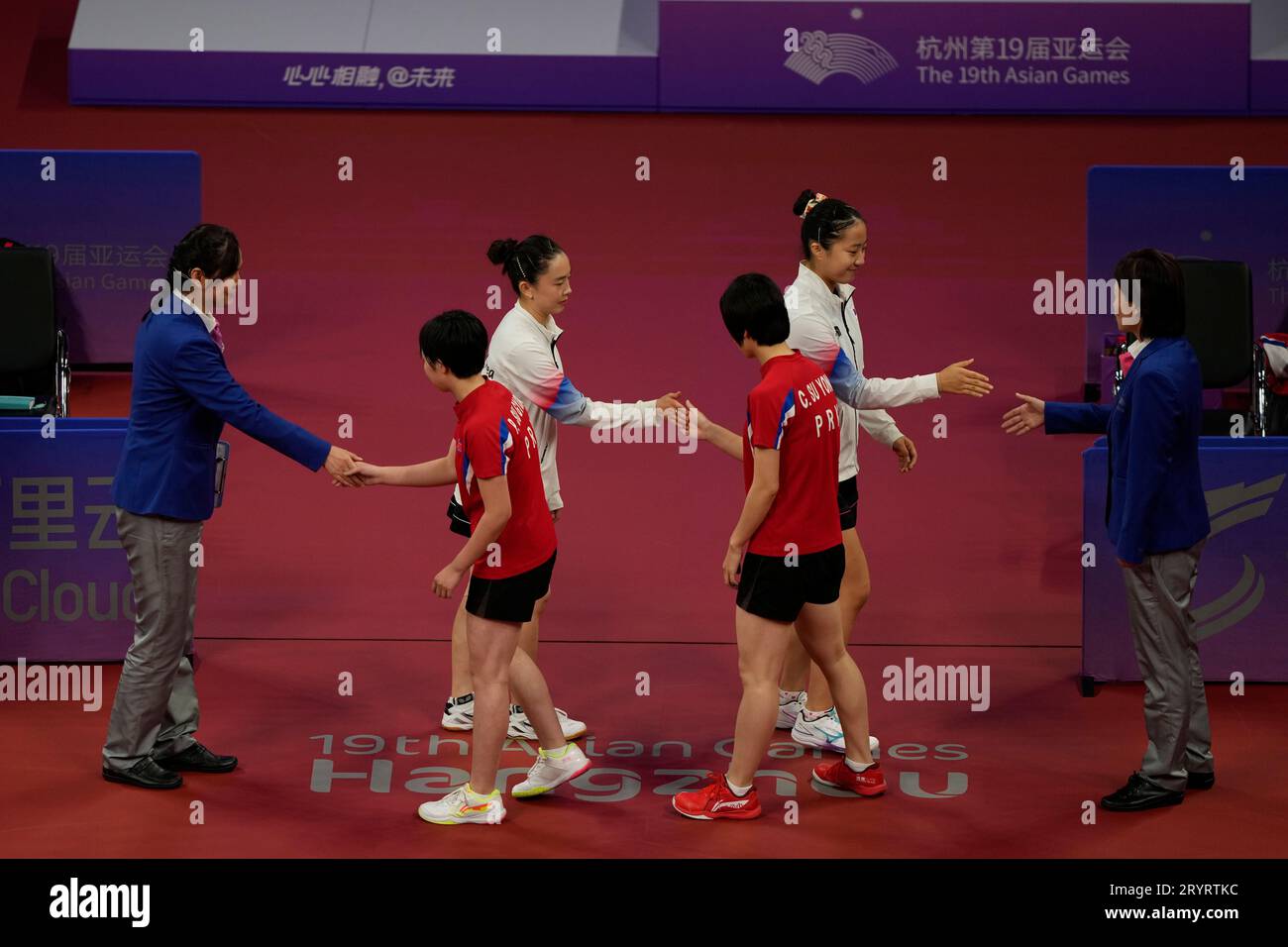 North Koreans Cha Suyong and Pak Sugyong in red shake hands with South ...