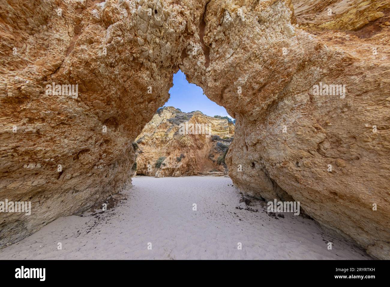 A stunningly beautiful arched rock formation set amidst a vast desert ...