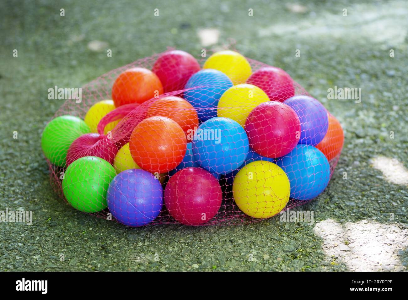 Color plastic toys at the child's legs. Plastic spheres of different ...