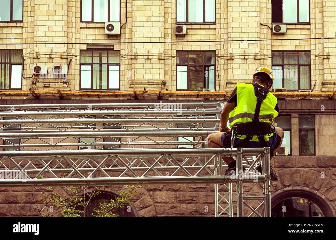 worker build a concert stage. Concept High-rise works. The worker in a ...