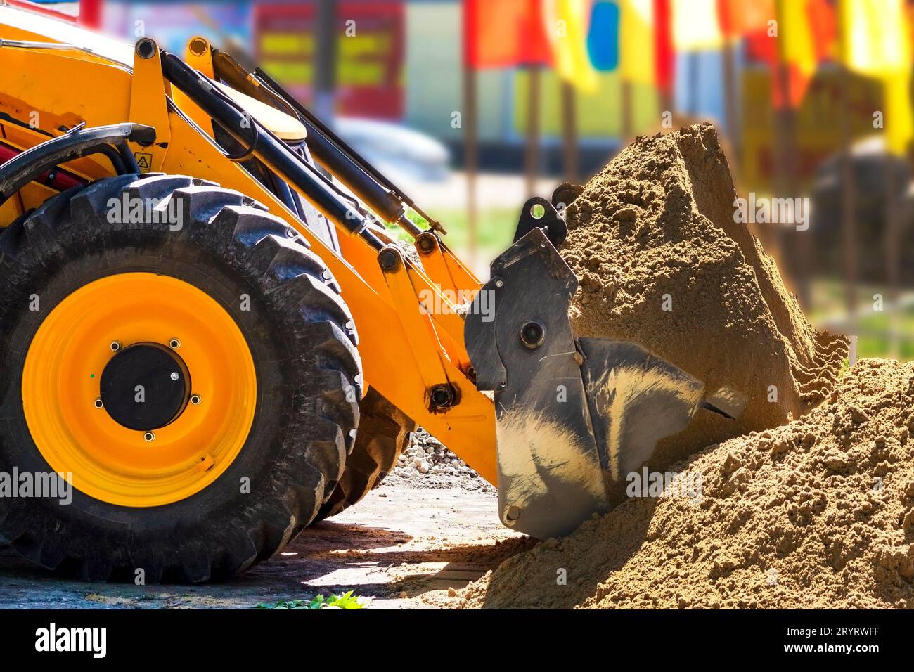 Excavator bucket with sand.Tractor near a pile of sand. Road ...