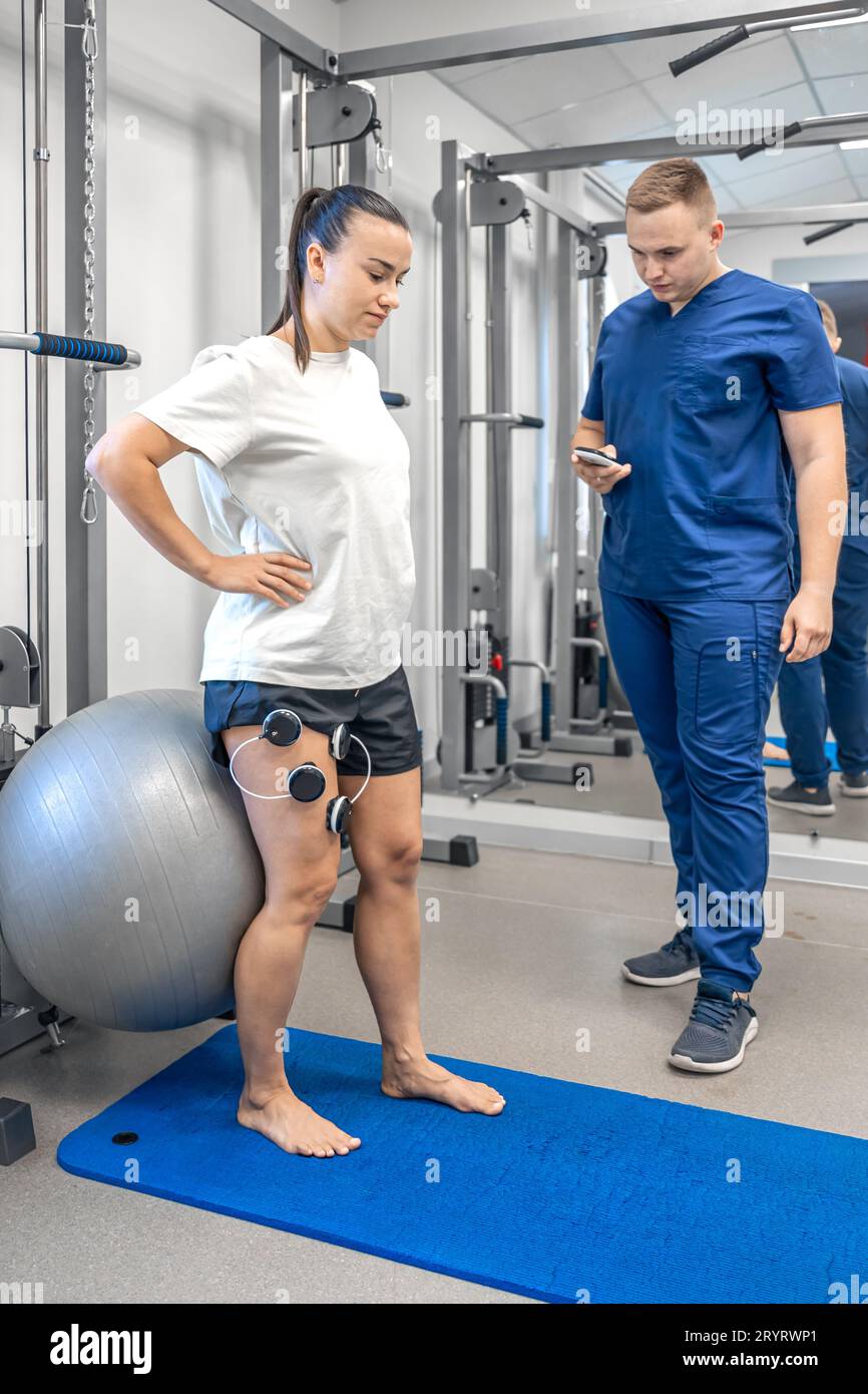The procedure of myostimulation on the legs of a woman Stock Photo - Alamy