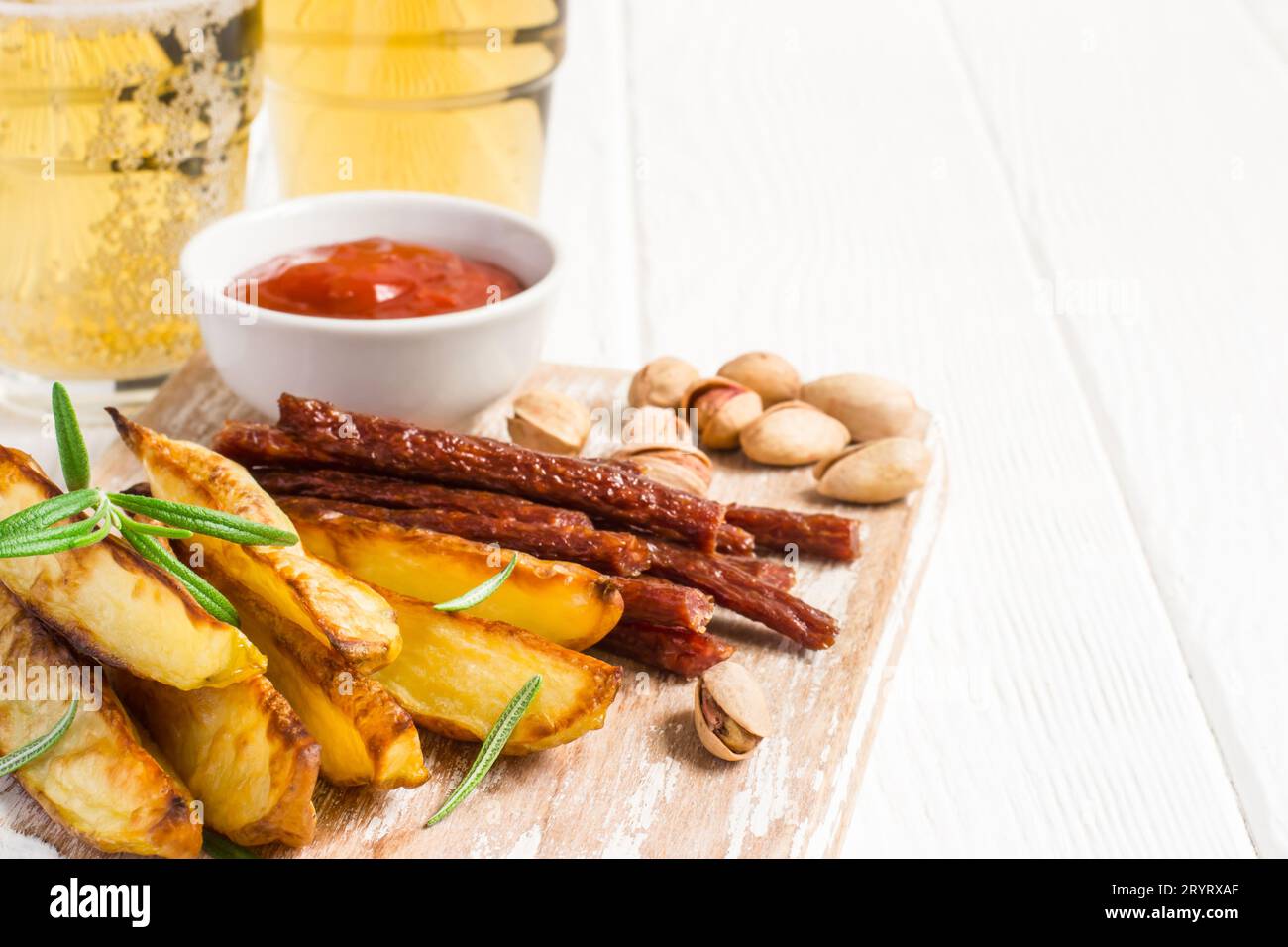 Set of different appetizers for beer are served on a cutting board and ...