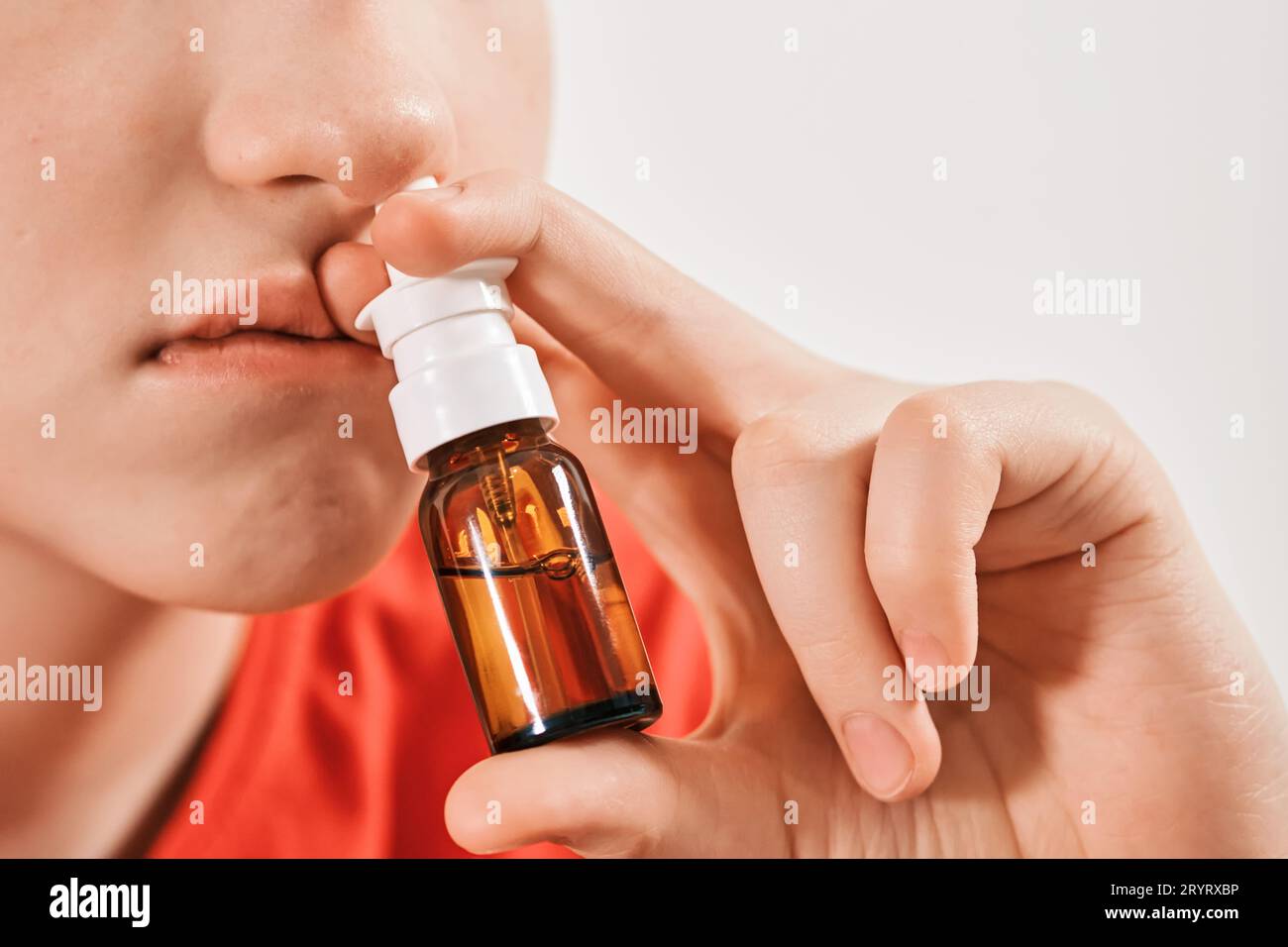 Blond Boy drips nose drops from runny nose. Treatment of colds and ...