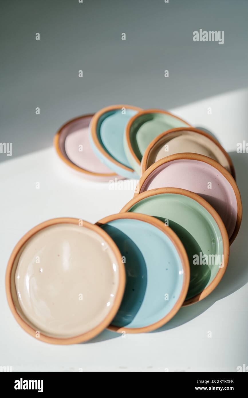 A large stack of ceramic cups in pastel colors Stock Photo - Alamy