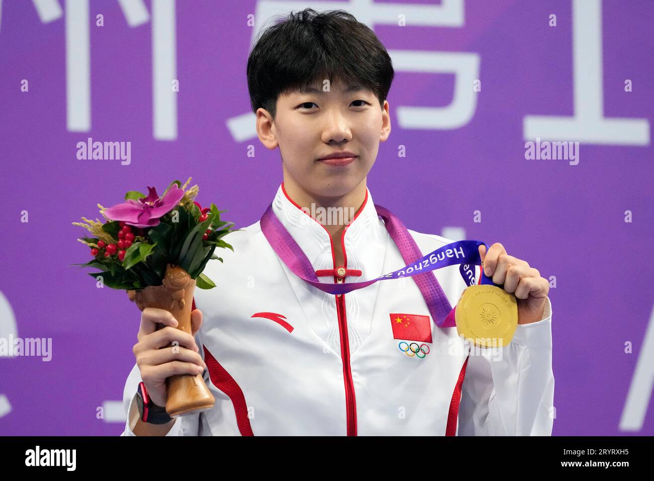 Li Yajie of Chinaholds her gold medal during the award ceremony for ...