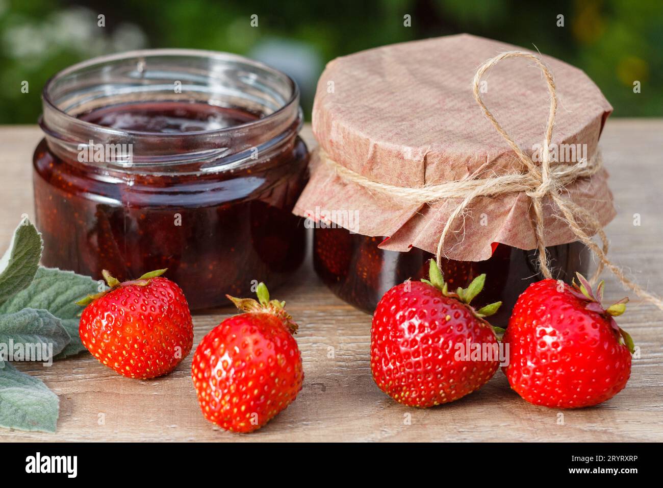 Traditional homemade strawberry jam in jars on wooden boards Stock ...
