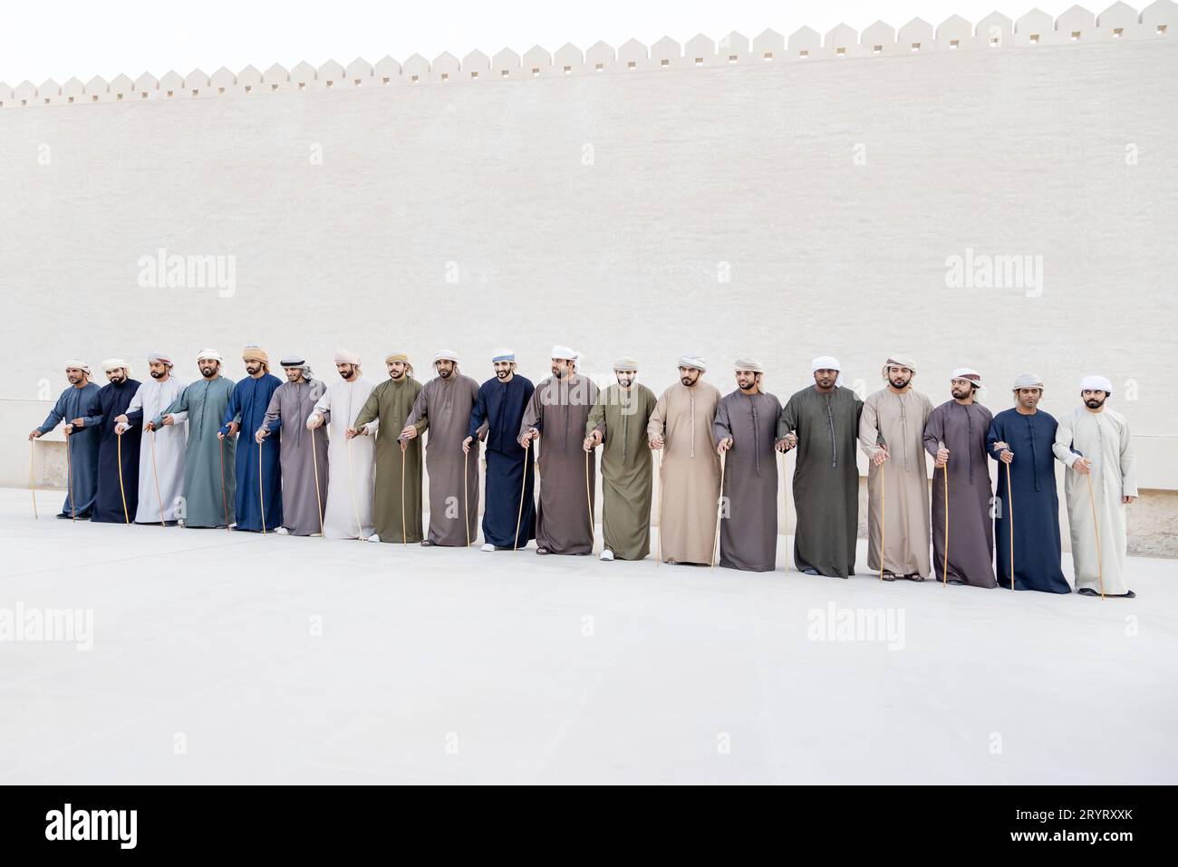 Abu Dhabi, UAE - January 21, 2023: Men in a line doing traditional ...