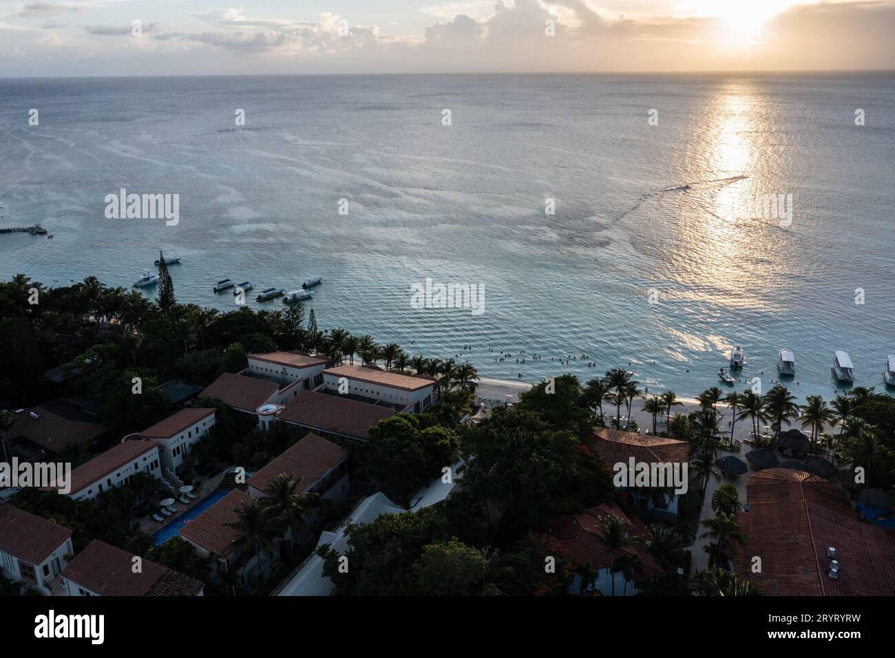 An aerial view of a coastal beach with crystal blue waters and white ...