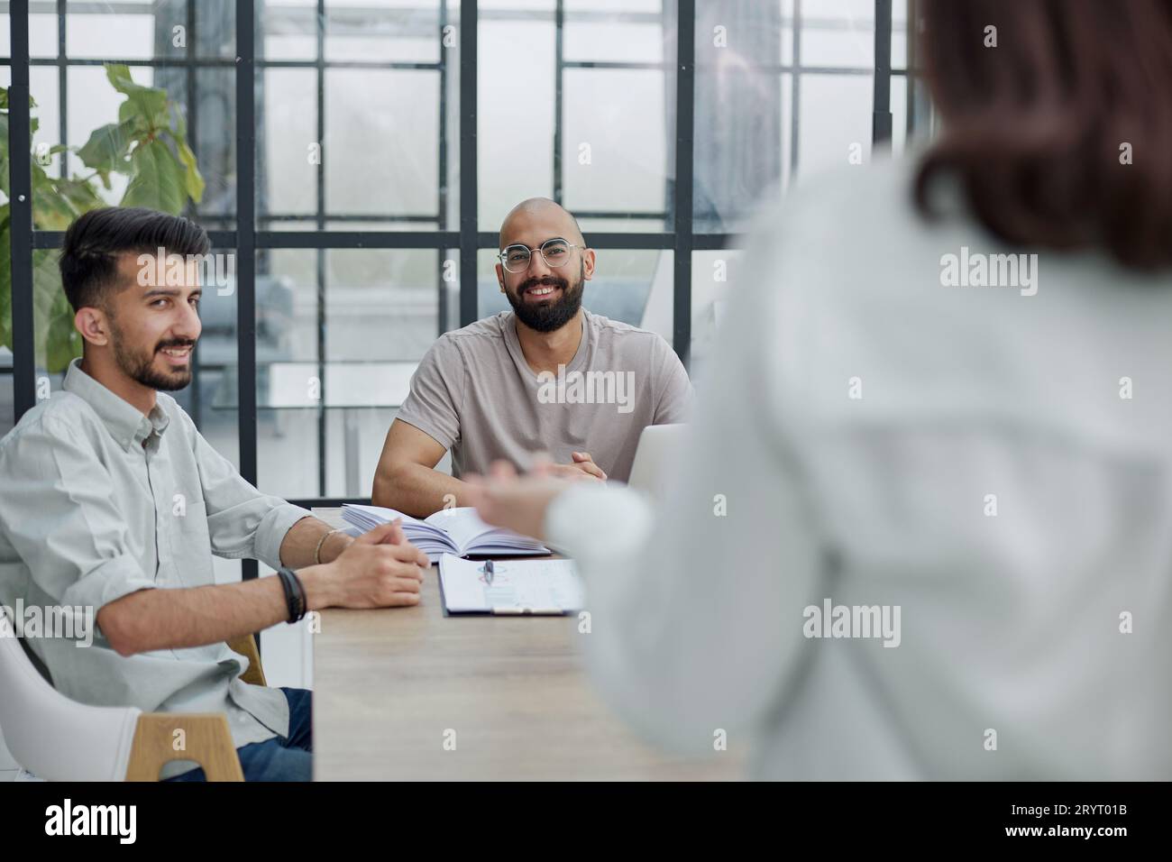 Rear view female participant sharing personal problem with colleagues ...
