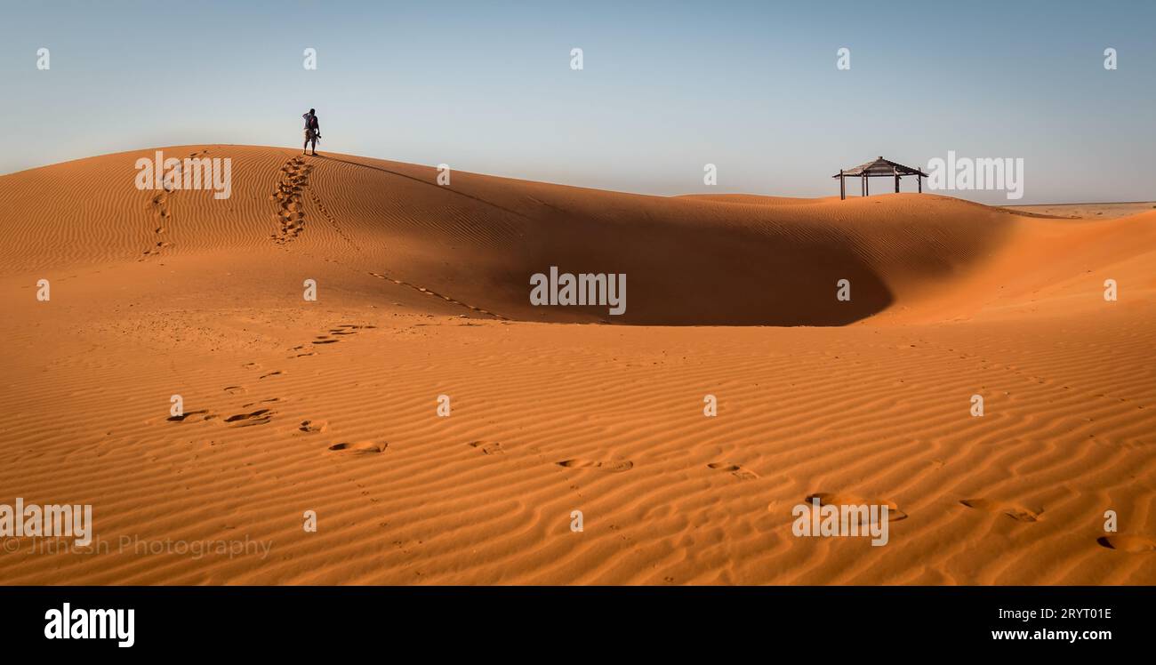 A man walking alone in the desert of Alain , UAE Stock Photo - Alamy