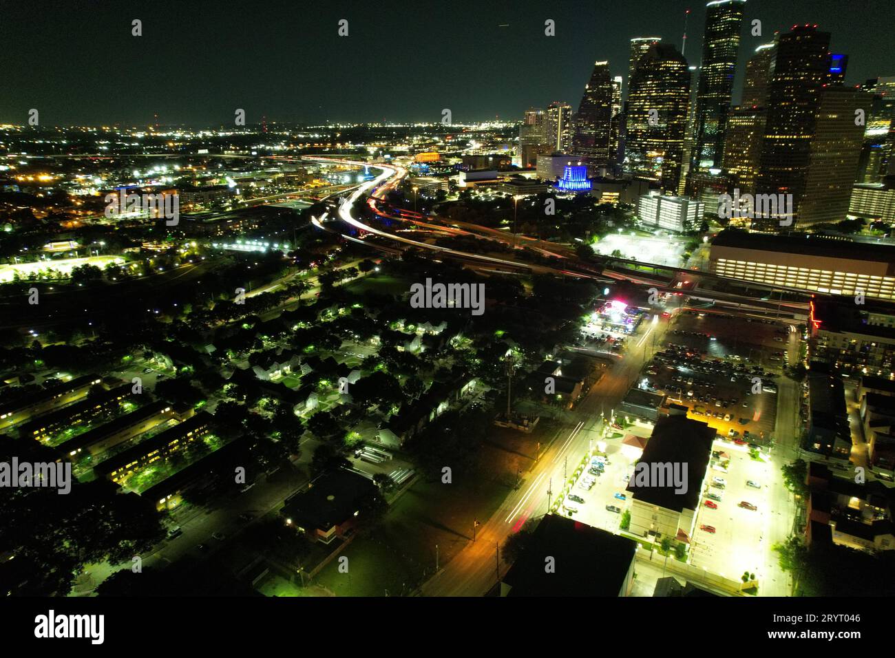 An aerial view of the vibrant Houston skyline at night with illuminated ...