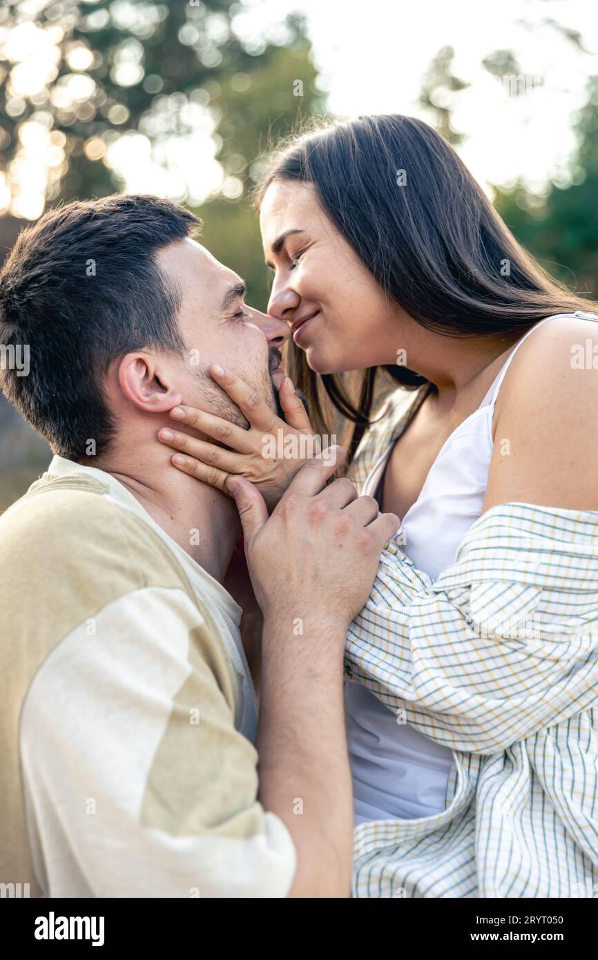 Happy man and woman tenderly touch each other outside Stock Photo - Alamy