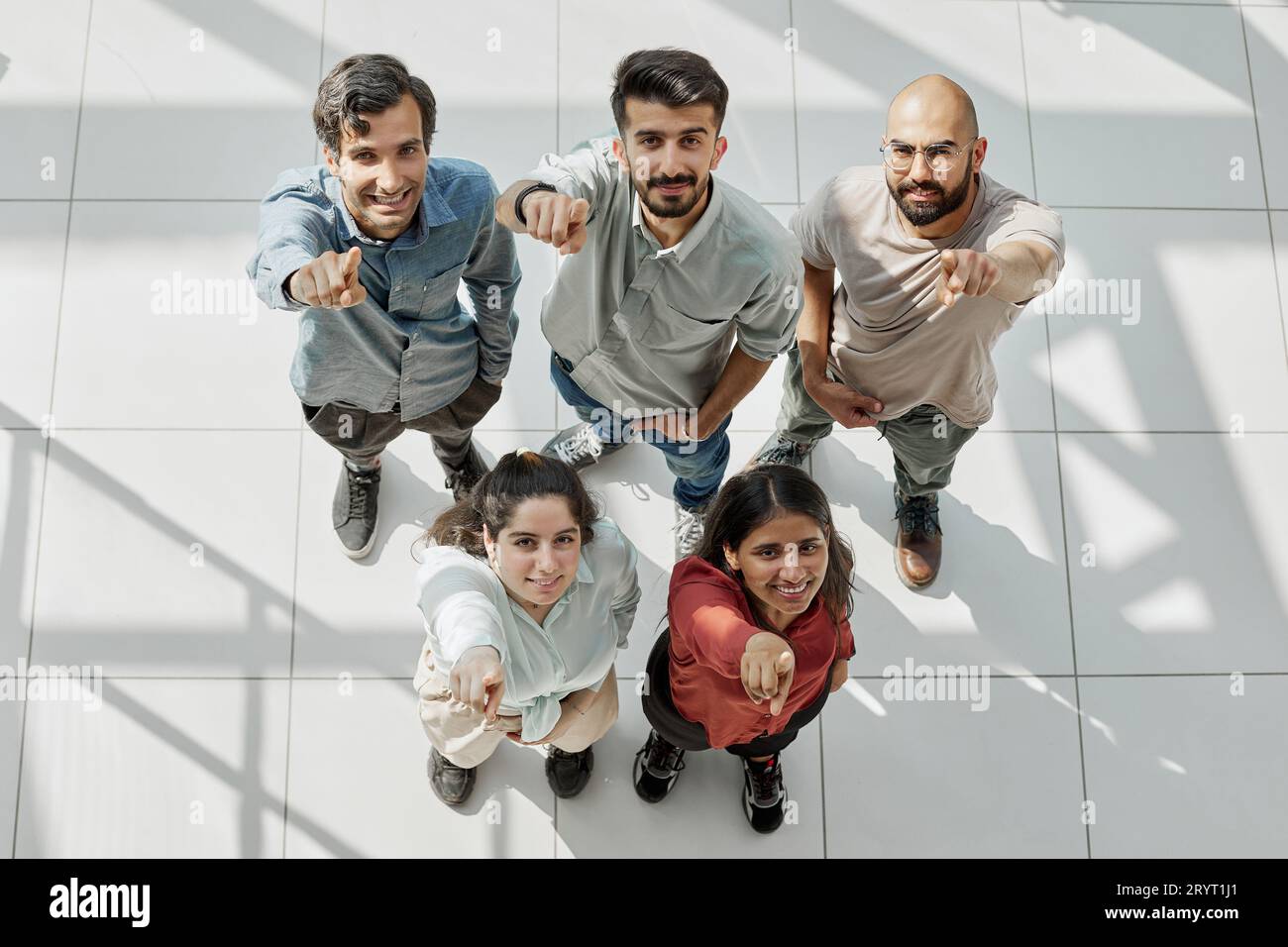 top view. lots of diverse young people looking up Stock Photo - Alamy