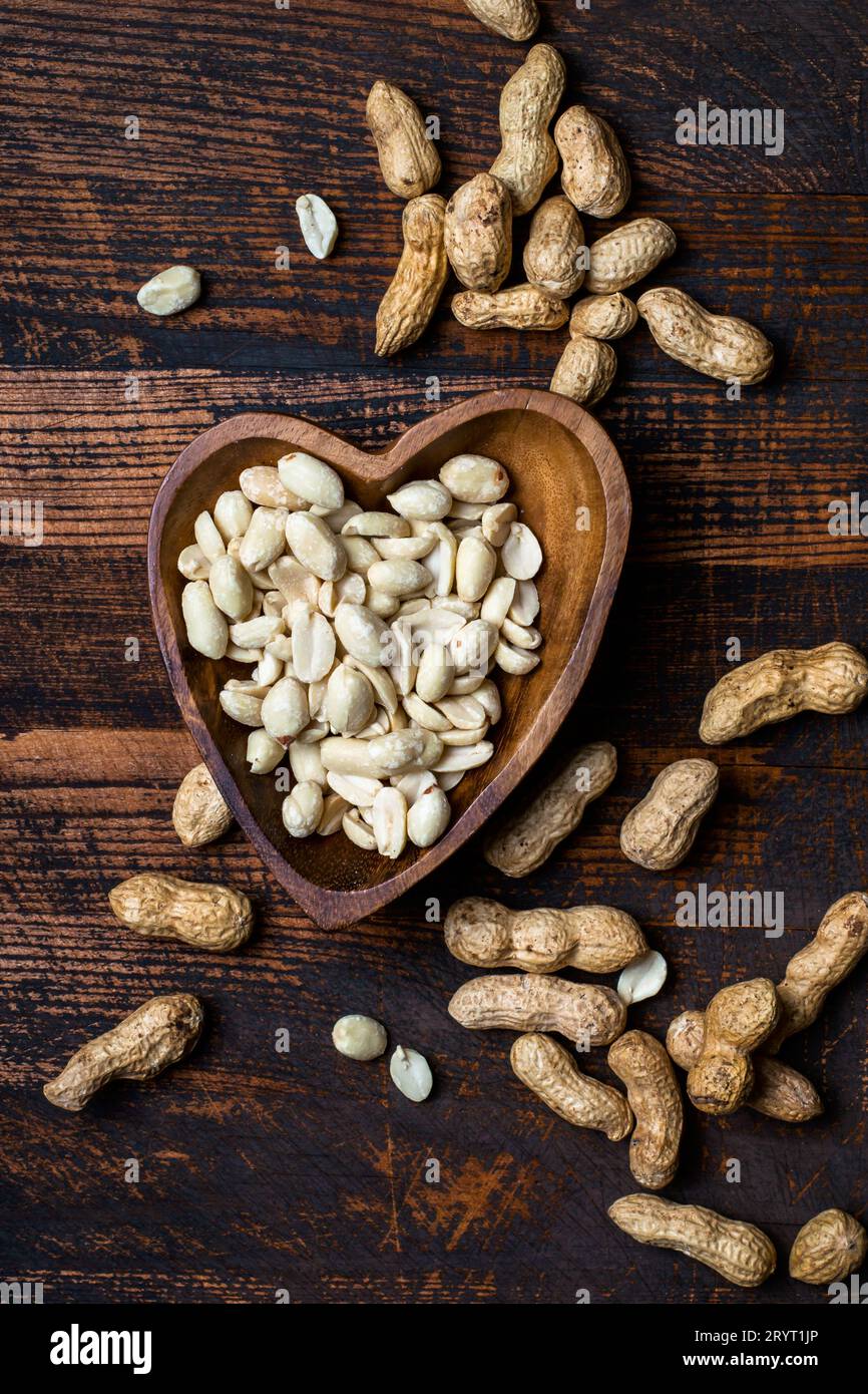 Peanuts snack in bowl on dark background Stock Photo - Alamy