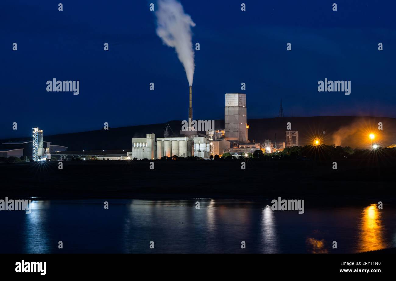 Dunbar cement works lit up at night with light reflections and ...