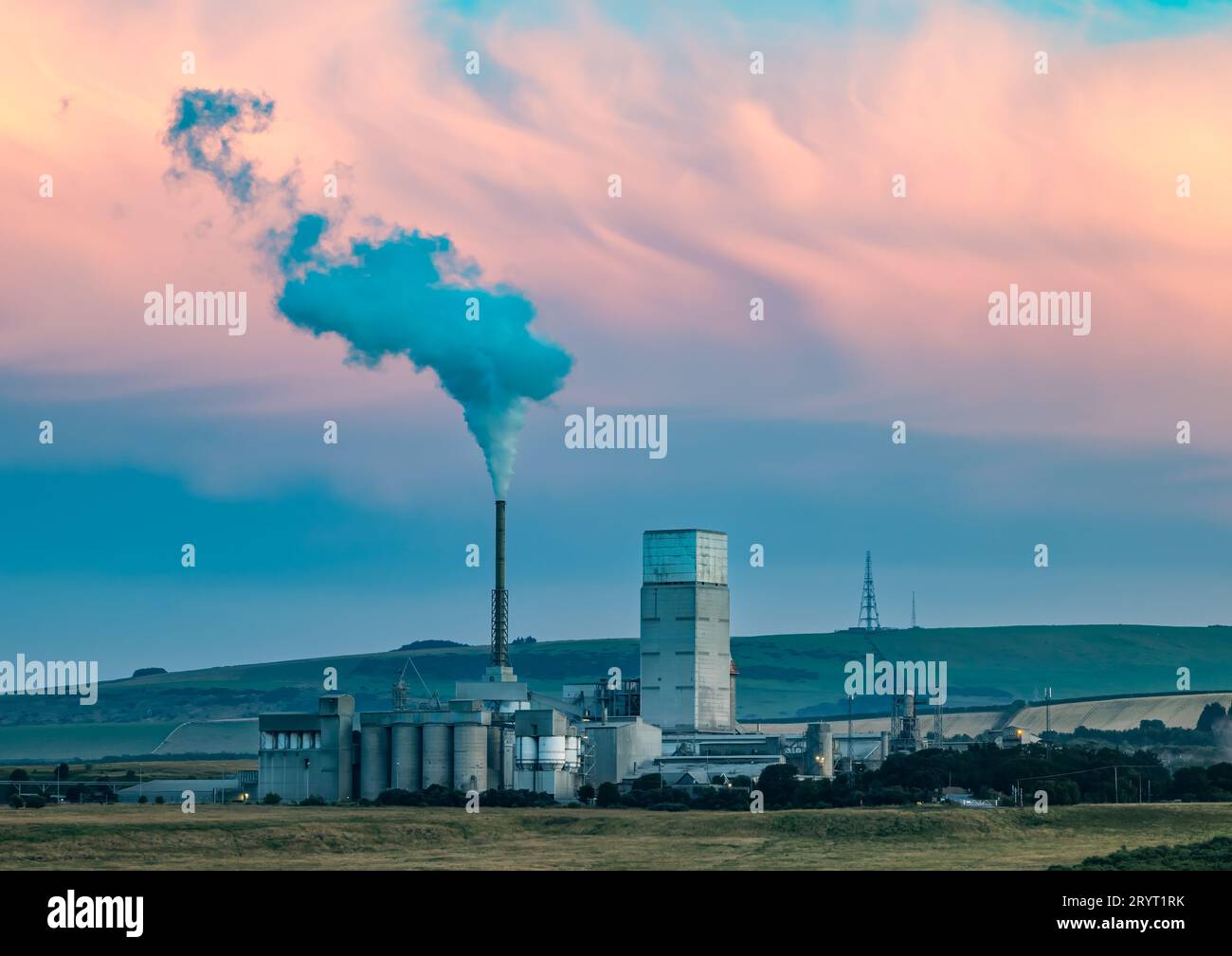Dunbar cement works at sunset with industrial steam tower, East Lothian ...