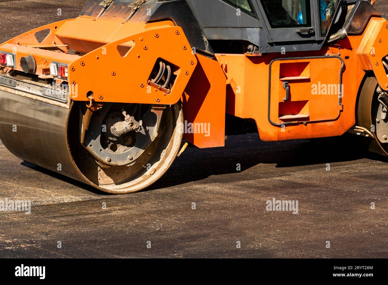 Vibratory asphalt roller compactor compacting new asphalt pavement ...