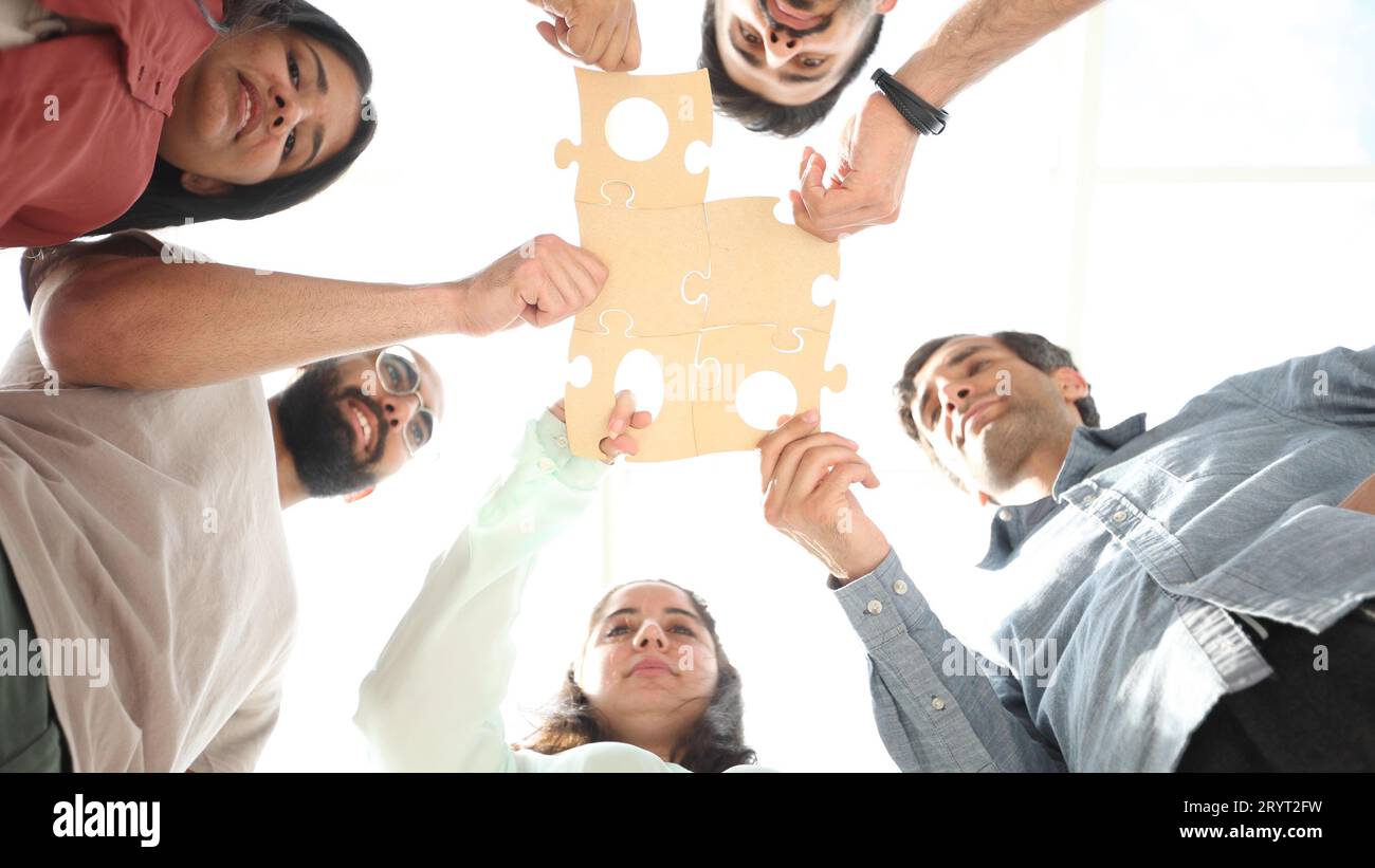 Group of business people assembling jigsaw puzzle and represent team ...