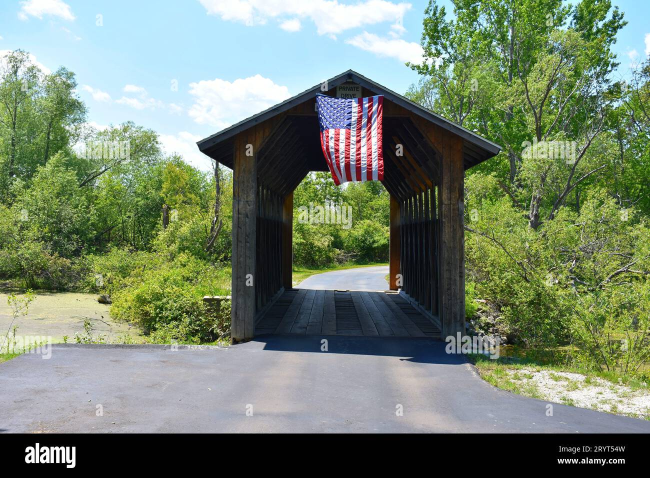 American flag hangs from wooden bridge Stock Photo - Alamy