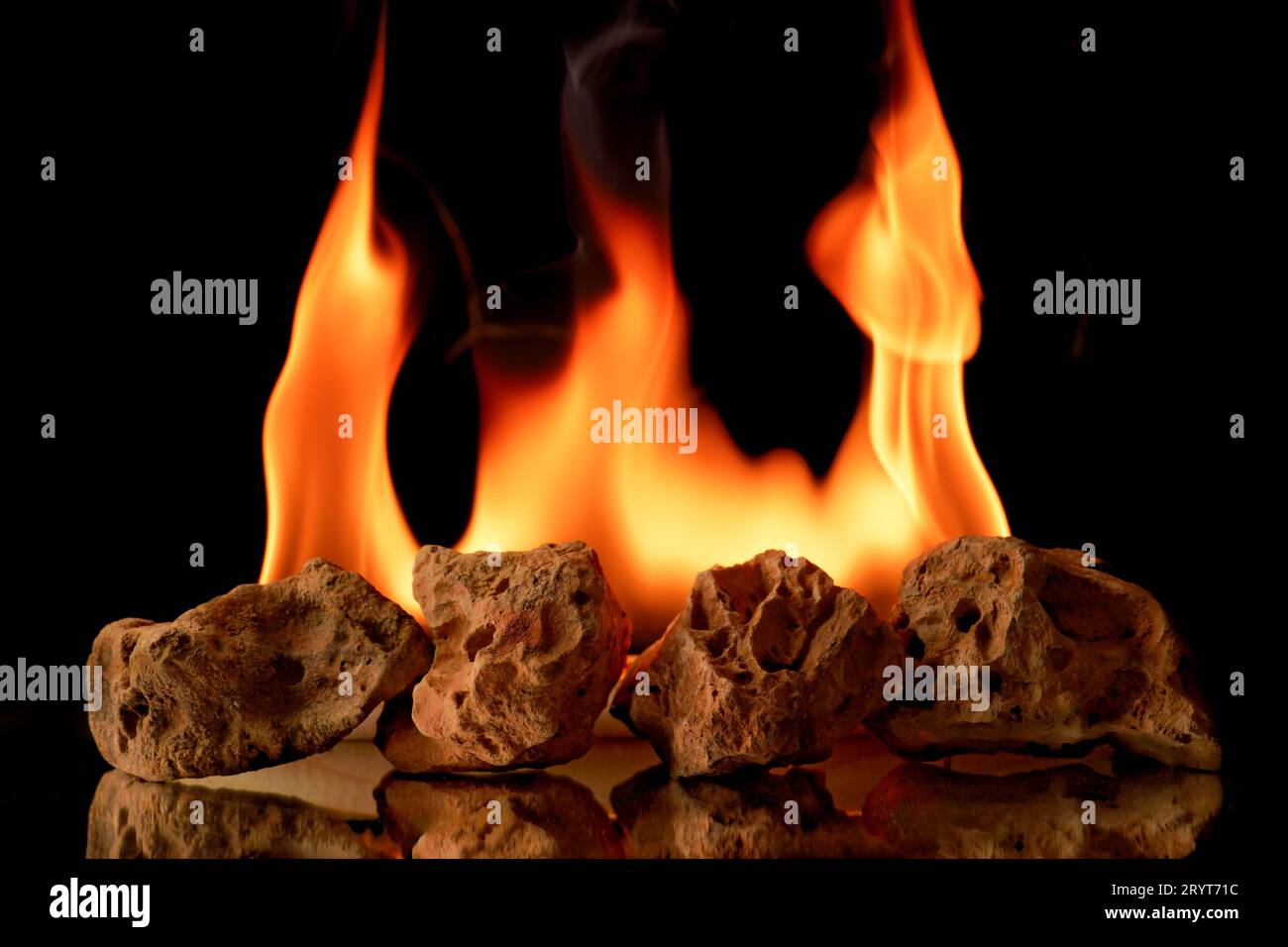Group of colorful stones with fire flames reflected on the ground ...