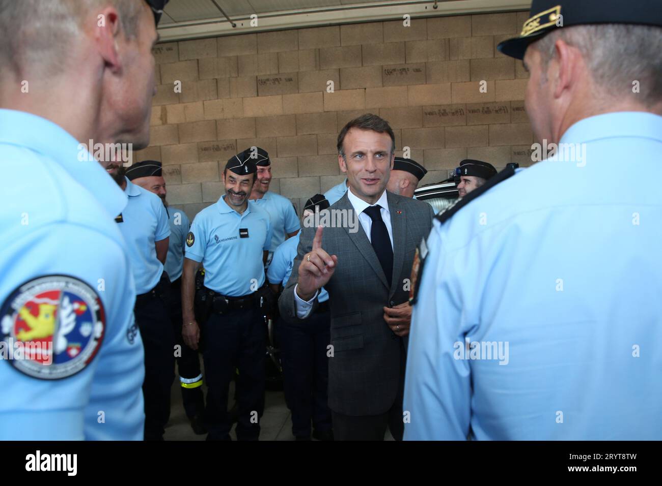 French President. Emmanuel Macron talks to officers as he inaugurates a ...