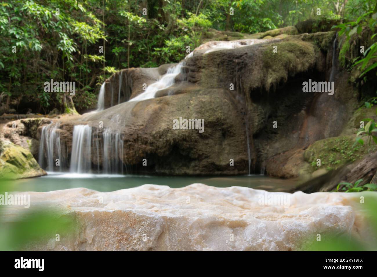 Stone table top podium floor in outdoor waterfall green tropical forest ...