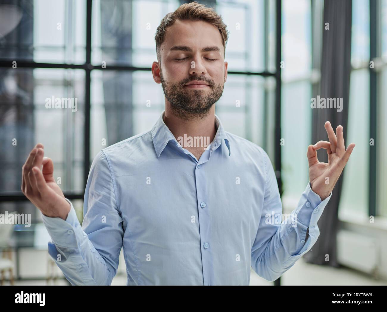 Young worker having break and resting after solving task Stock Photo ...