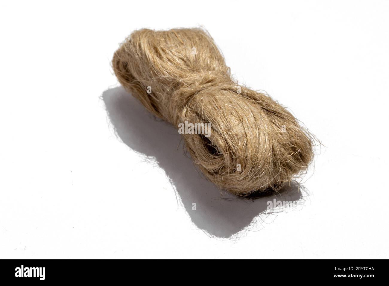 A ball of rust-colored yarn placed atop a white background Stock Photo ...