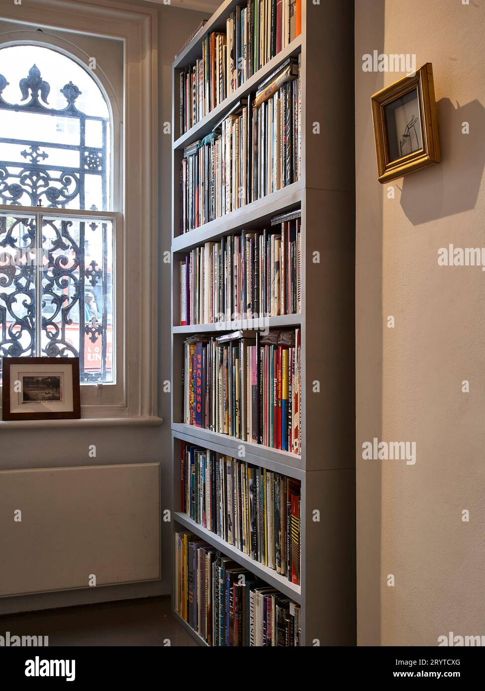 Large bookcase on landing by first floor window. End House, Kensington ...
