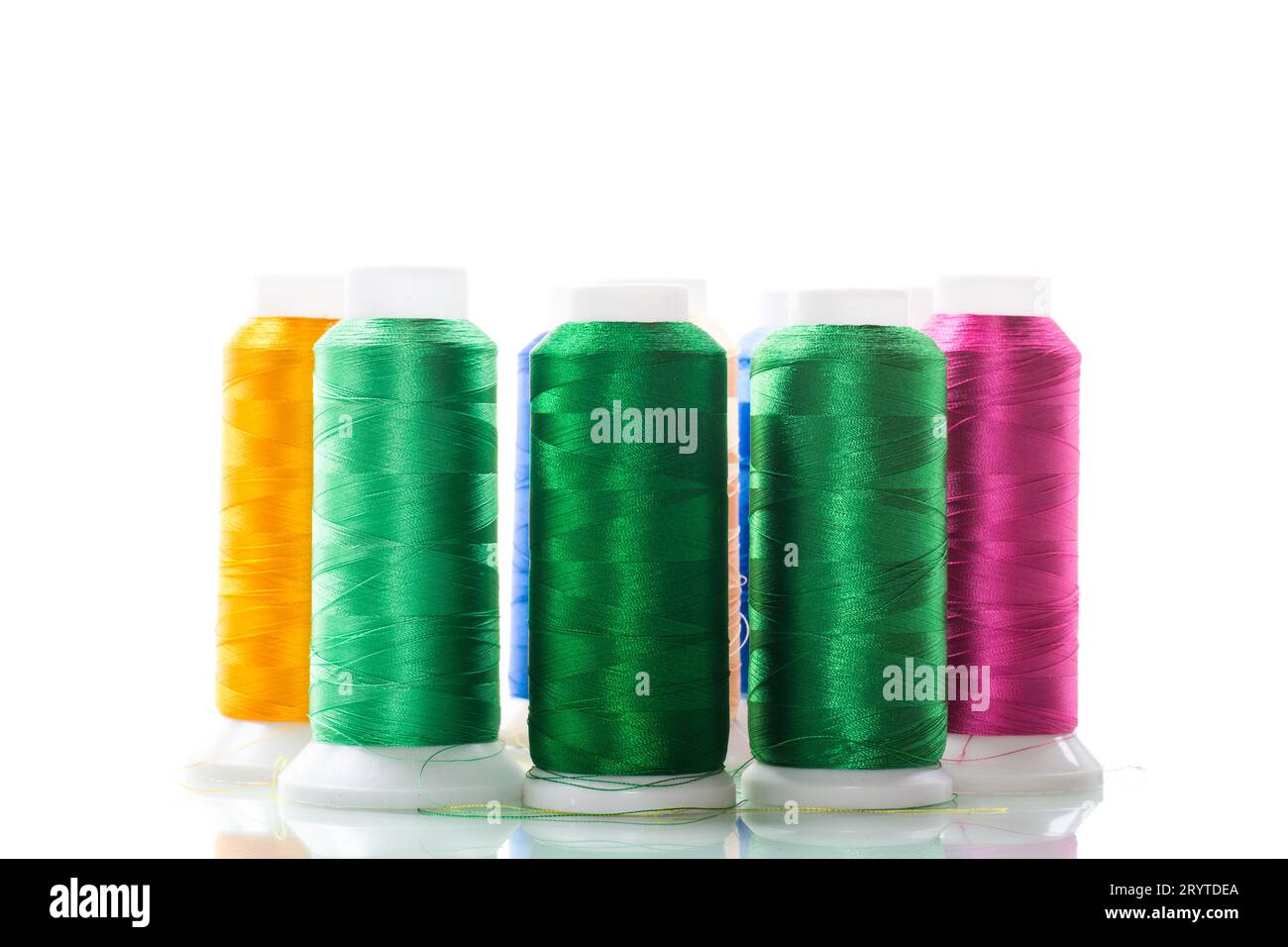 set of different color sewing threads, isolated on white background ...
