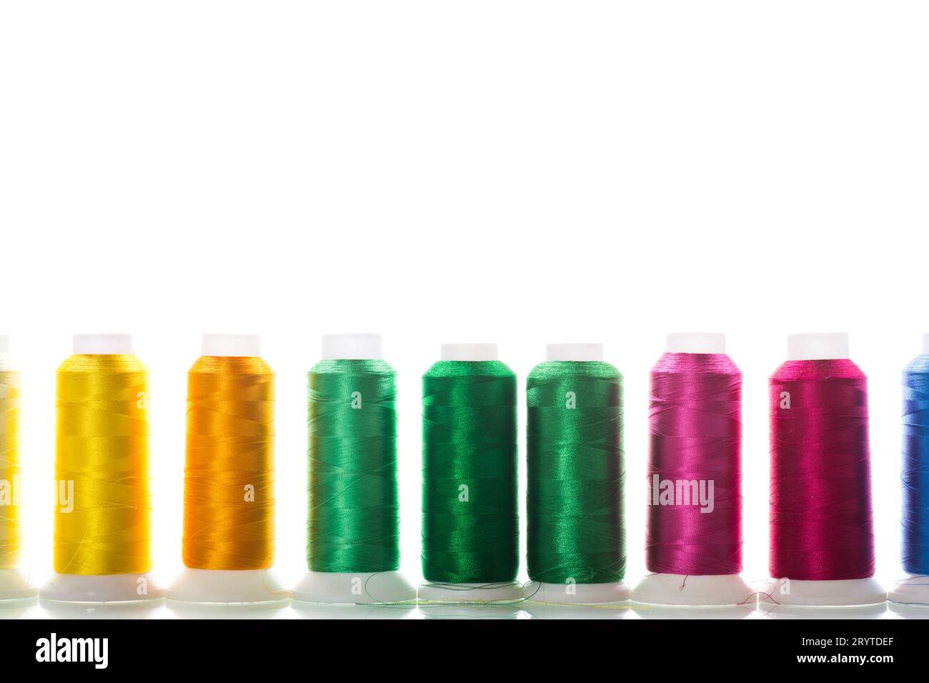 set of different color sewing threads, isolated on white background ...