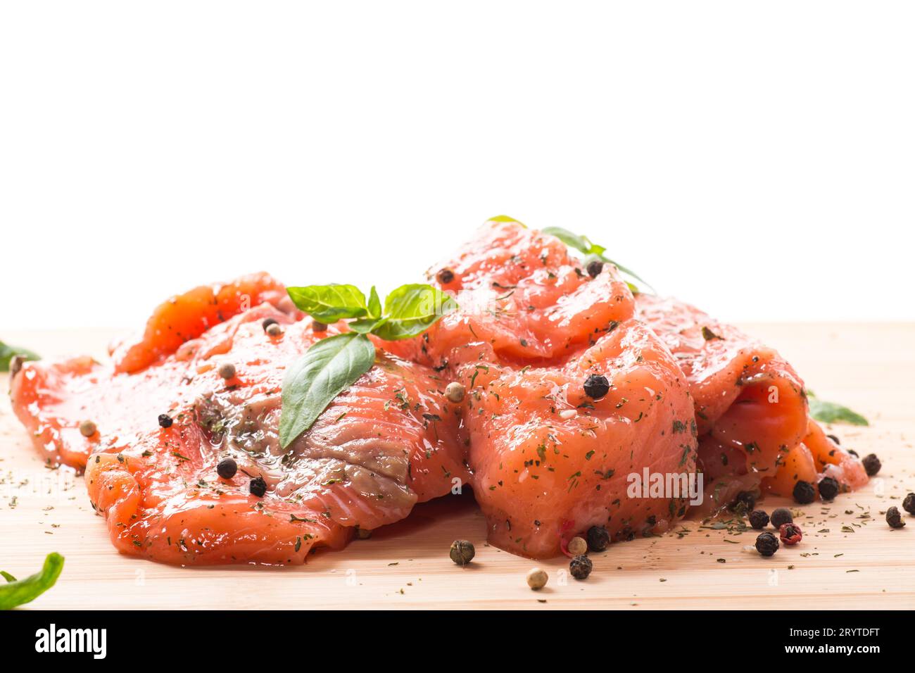 Fresh big pieces of salted red fish with spices and herbs on a wooden ...