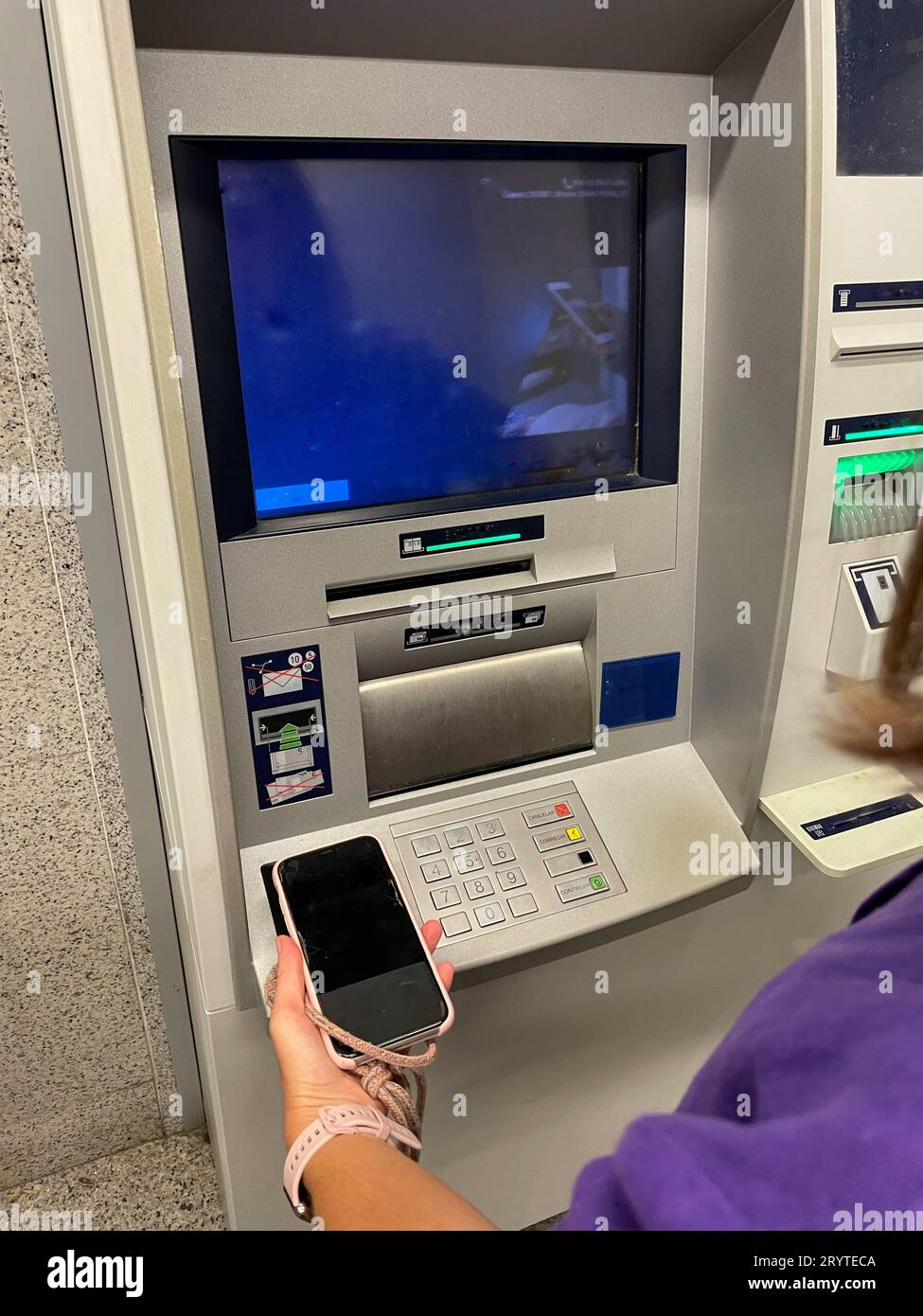 Withdrawing money at the atm with phone hi-res stock photography and ...