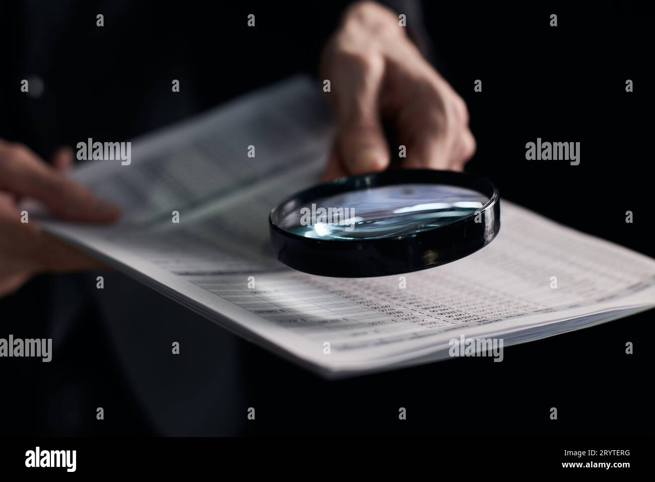 Businessman looking through a magnifying glass to contract Stock Photo ...