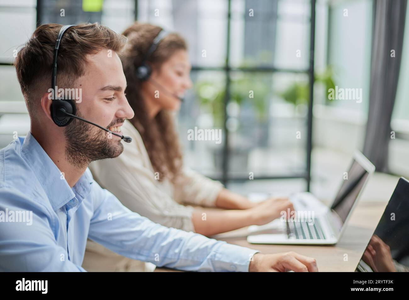 Customer Service Representative With Colleague Working In Office Stock ...
