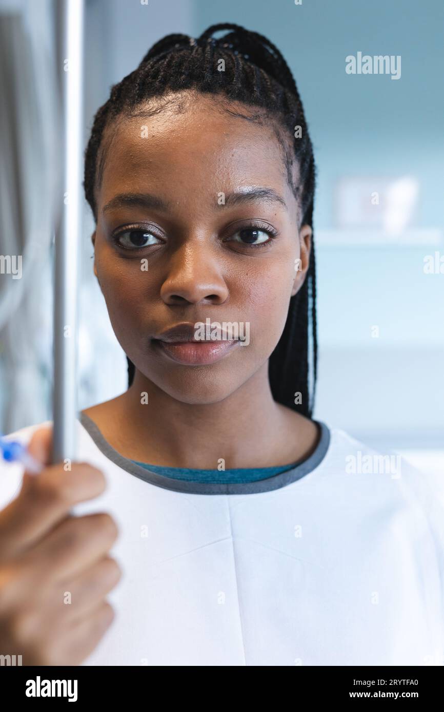 Portrait of african american female patient with braids, wearing ...
