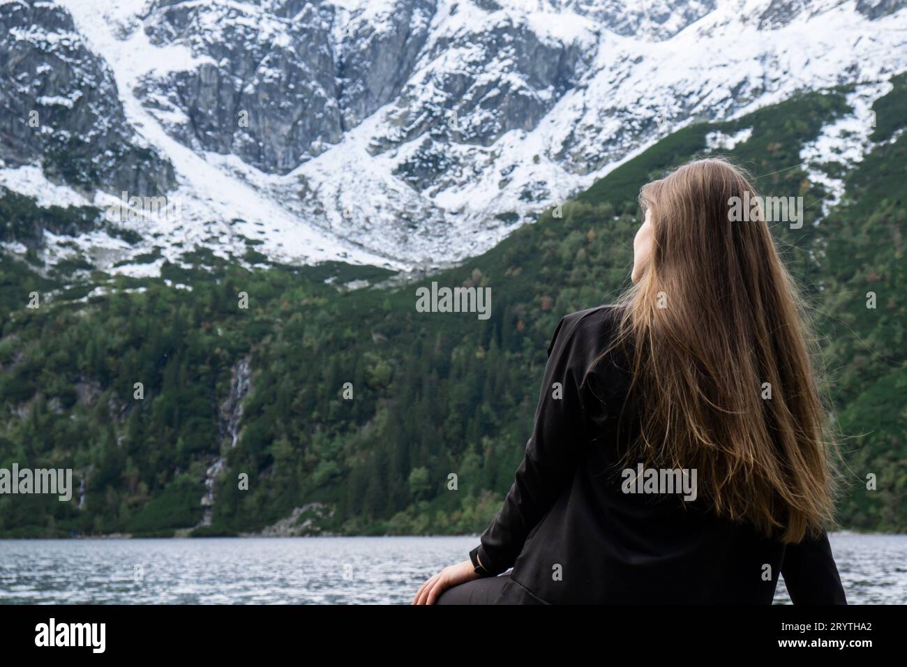 Young woman enjoying nature in Morskie Oko Snowy Mountain Hut in Polish ...