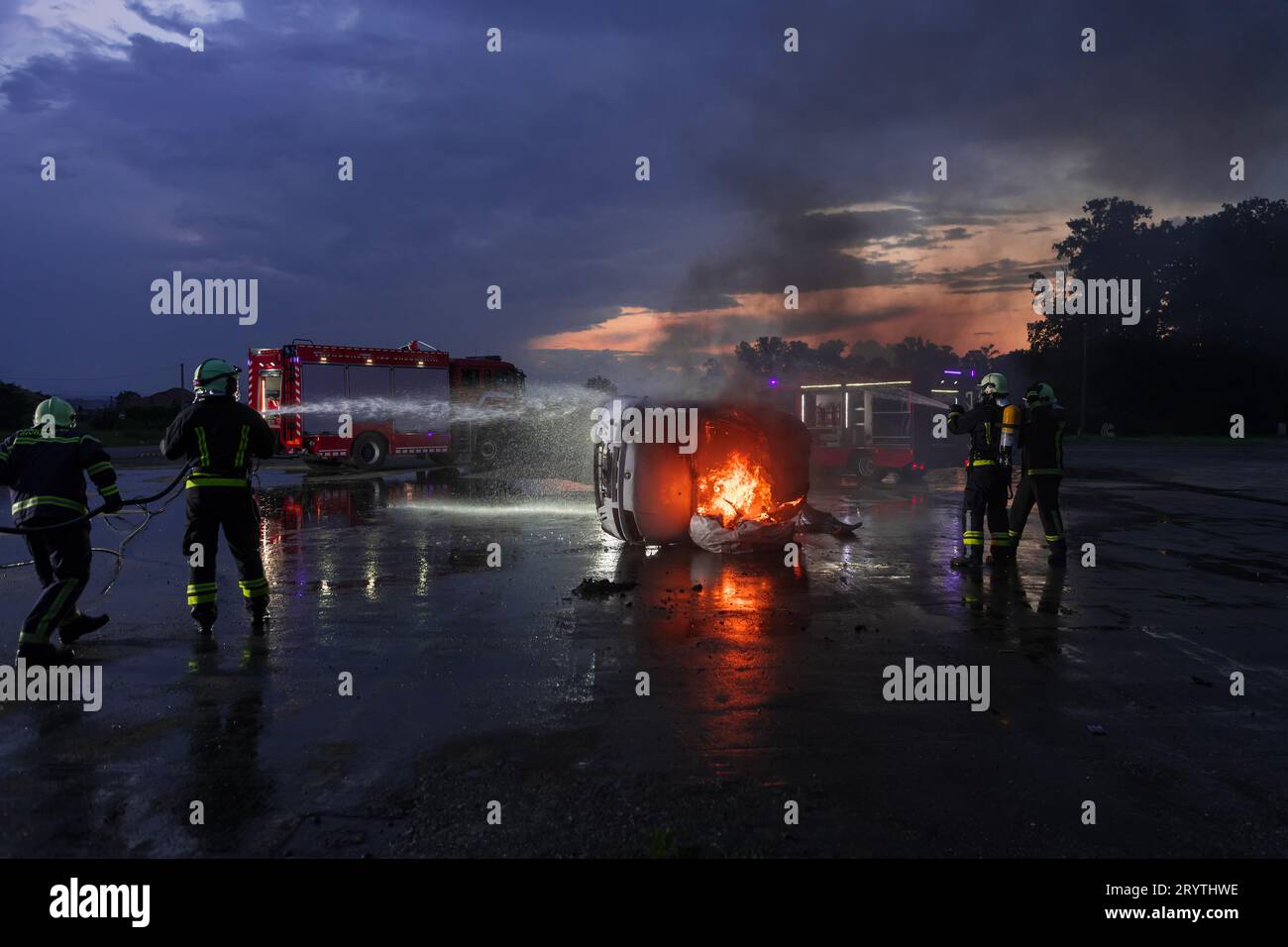 Firefighters fight the fire flame to control fire not to spreading out ...