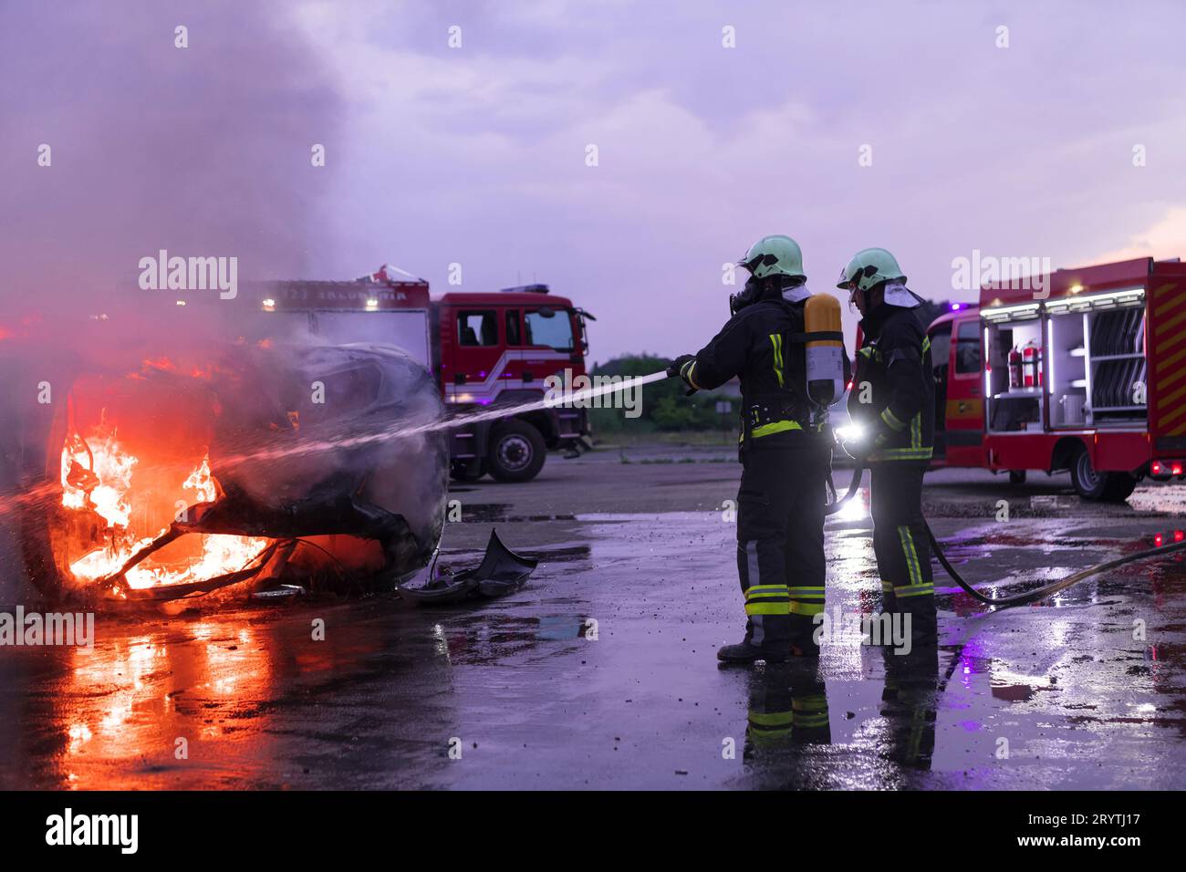 Firefighters fight the fire flame to control fire not to spreading out ...