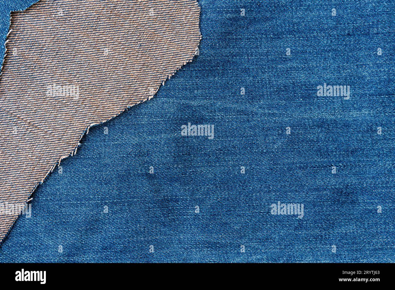 Destroyed torn denim blue jeans texture Stock Photo - Alamy