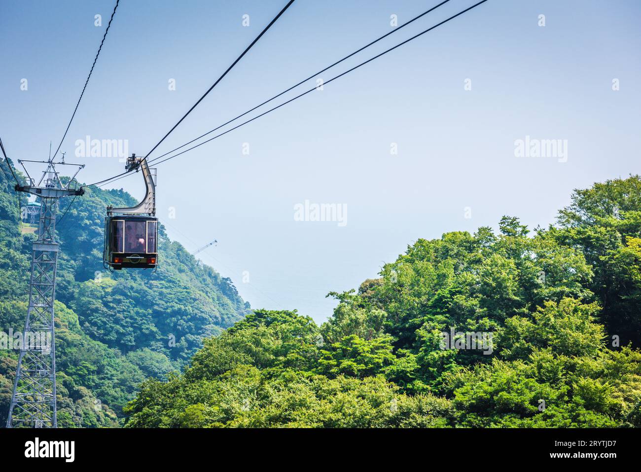 Nihondaira Ropeway - Cable car traveling over forested hills in ...