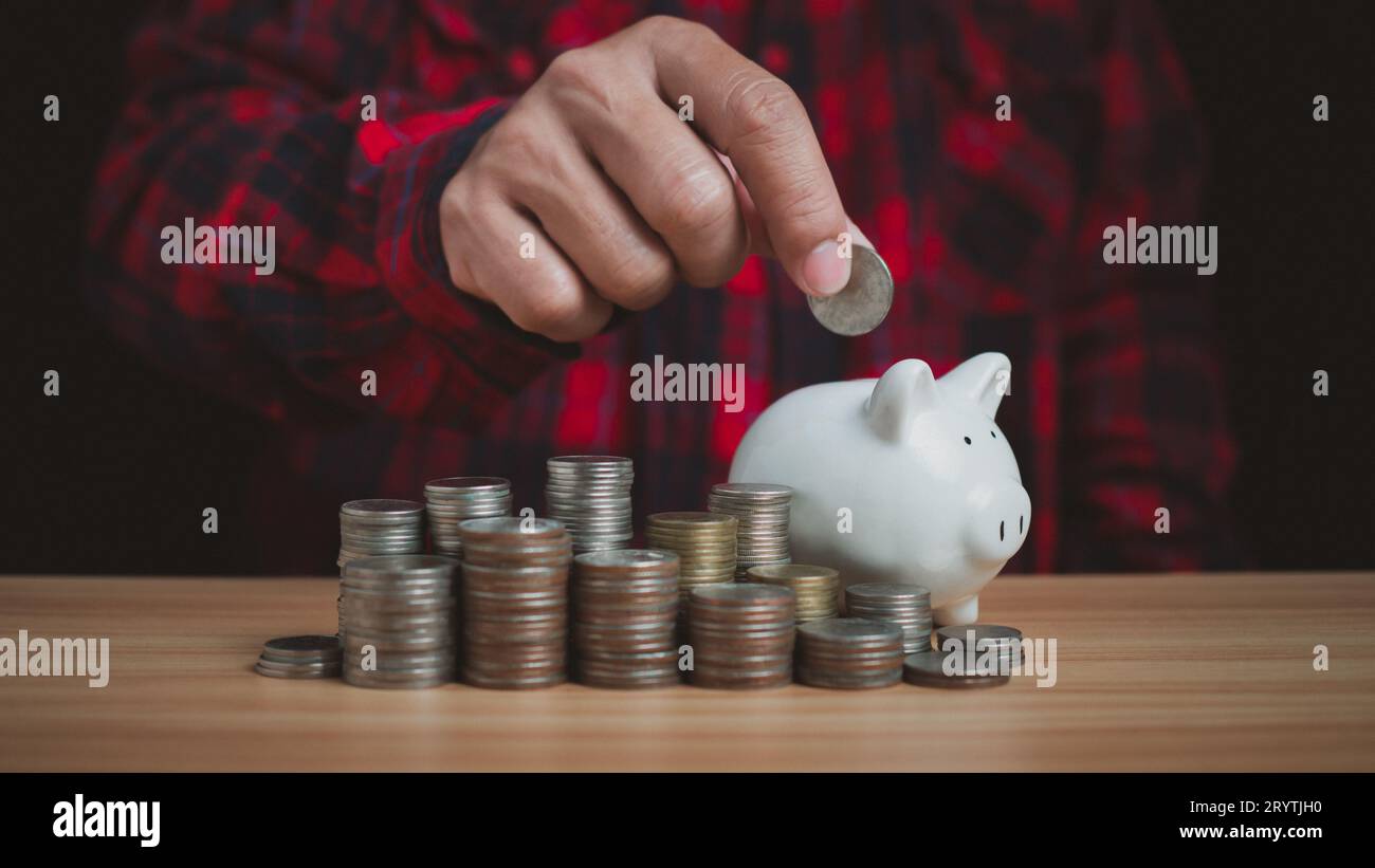 Human puts money on pile of piggy bank. Concepts of finance, savings ...