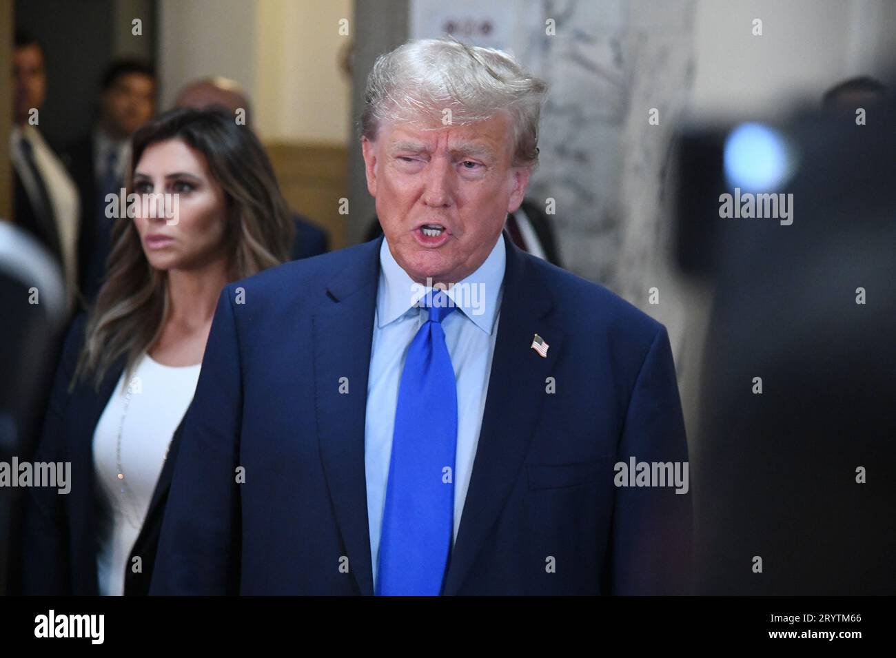 Former U.S. President Donald Trump speaks to members outside the ...